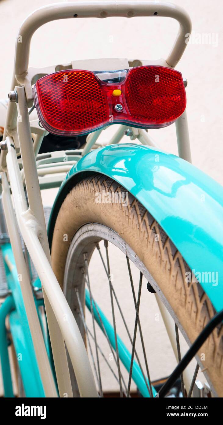 Red bicycle rear reflector and a rear wheel close up Stock Photo - Alamy