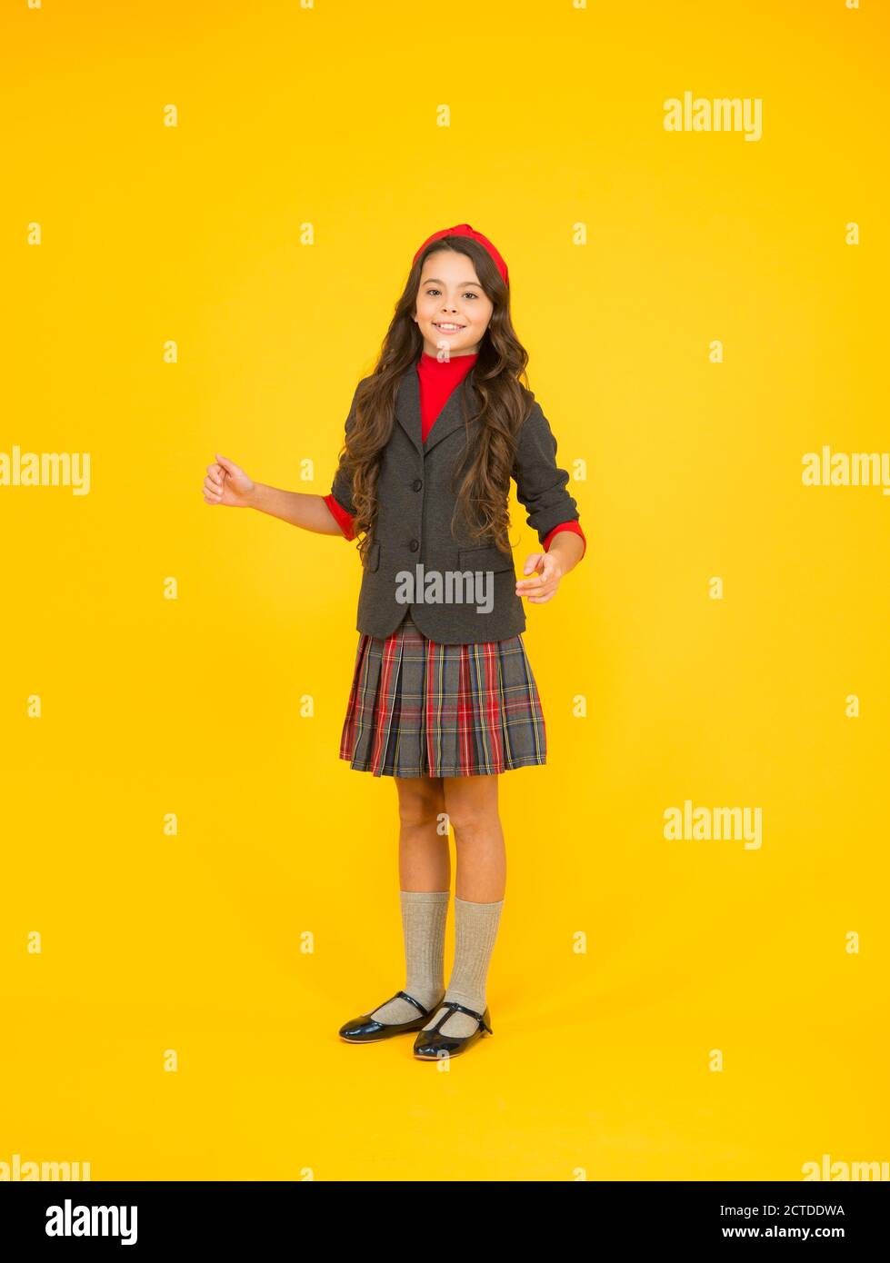 Keeping her smart. Happy child wear uniform yellow background. School ...