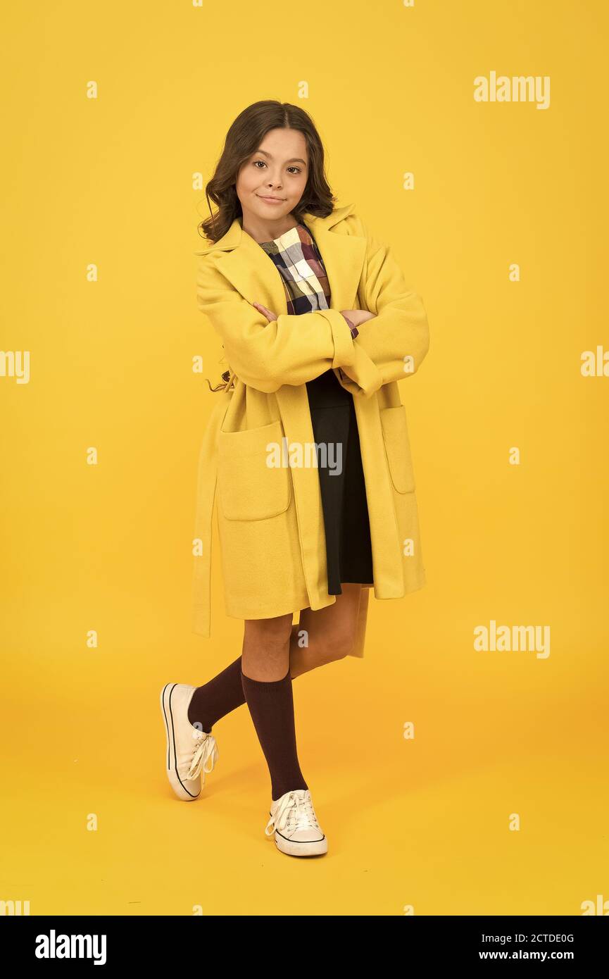 Fashion concept. Charismatic girl on yellow background. Elegant little ...