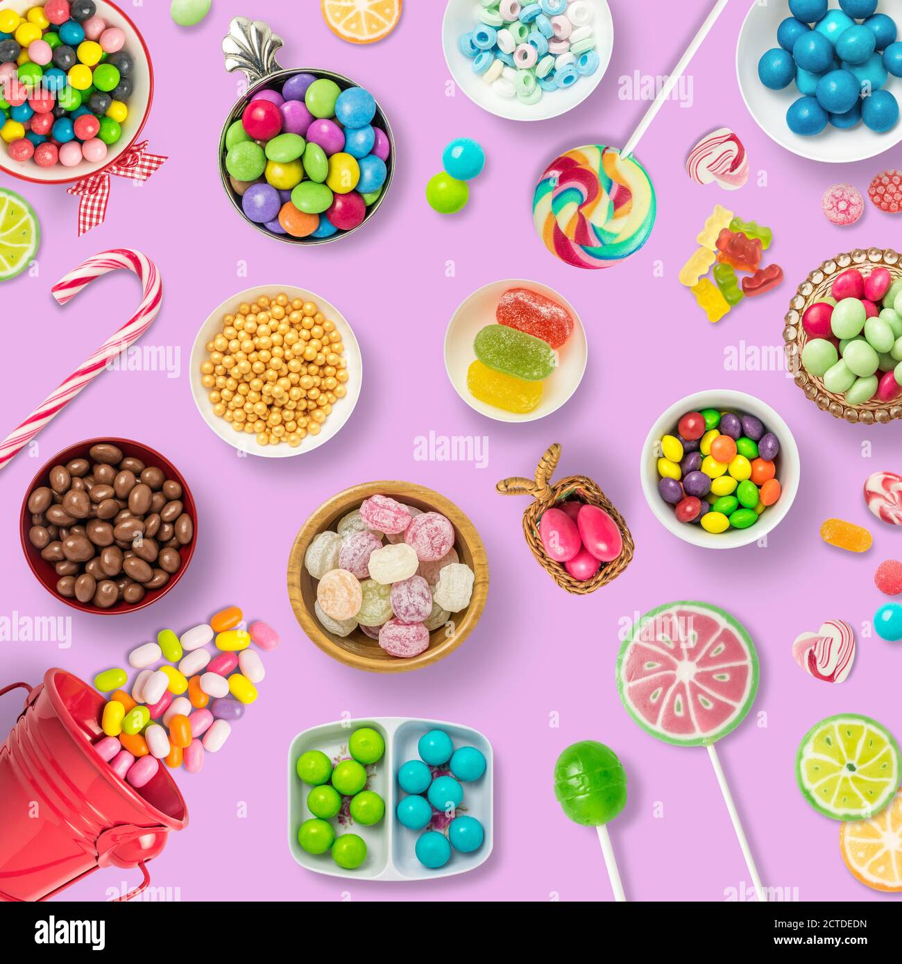Candies, chocolates and lollipops on a pink background background ...