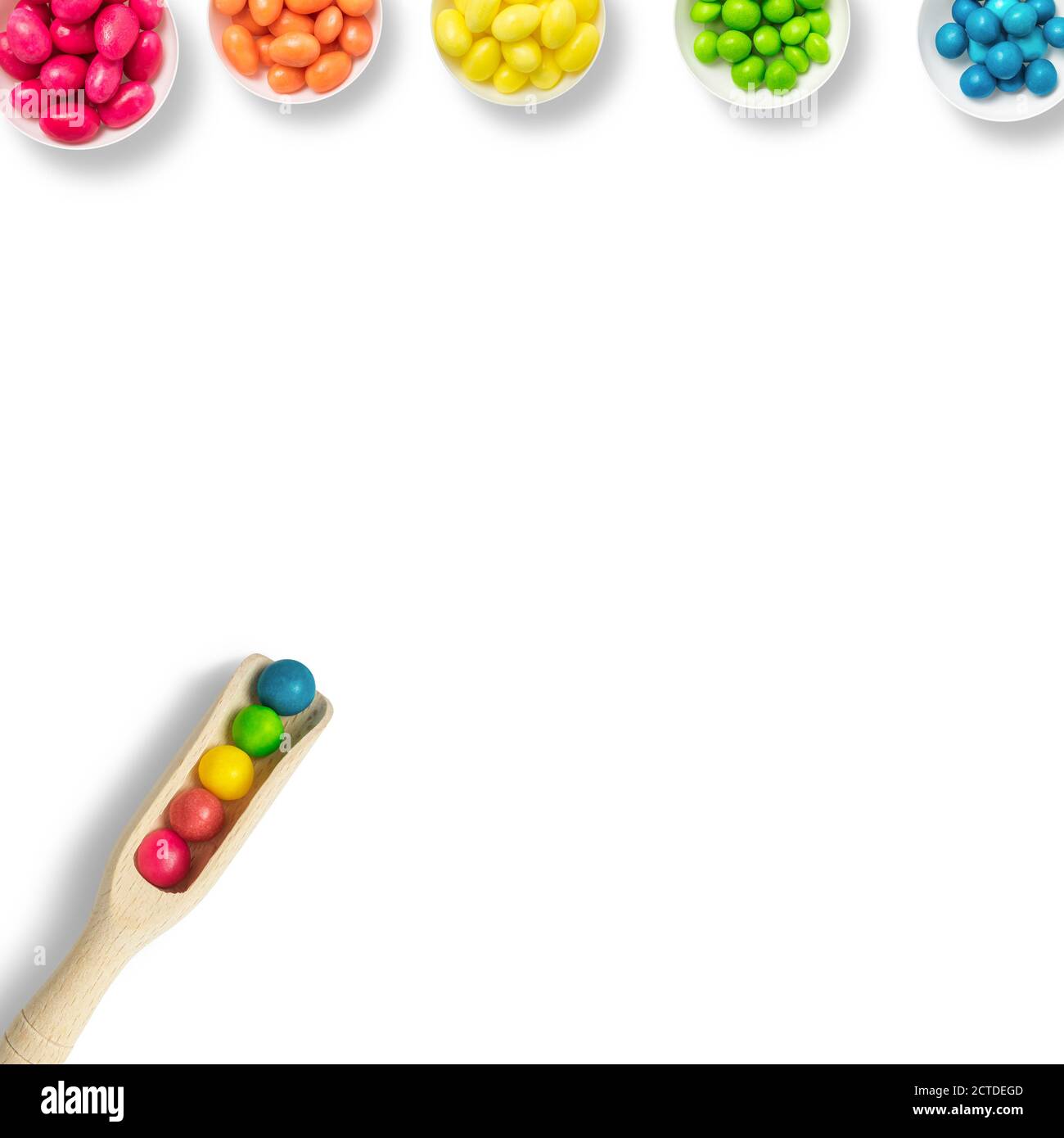 Colorful candies on a white background with copy space. Backdrop ...