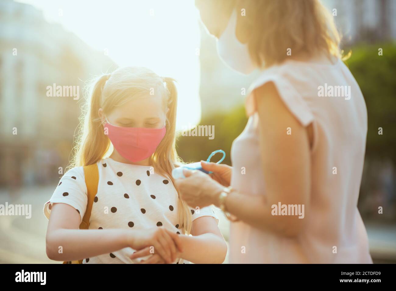 Life during covid-19 pandemic. modern mother and child with masks ...