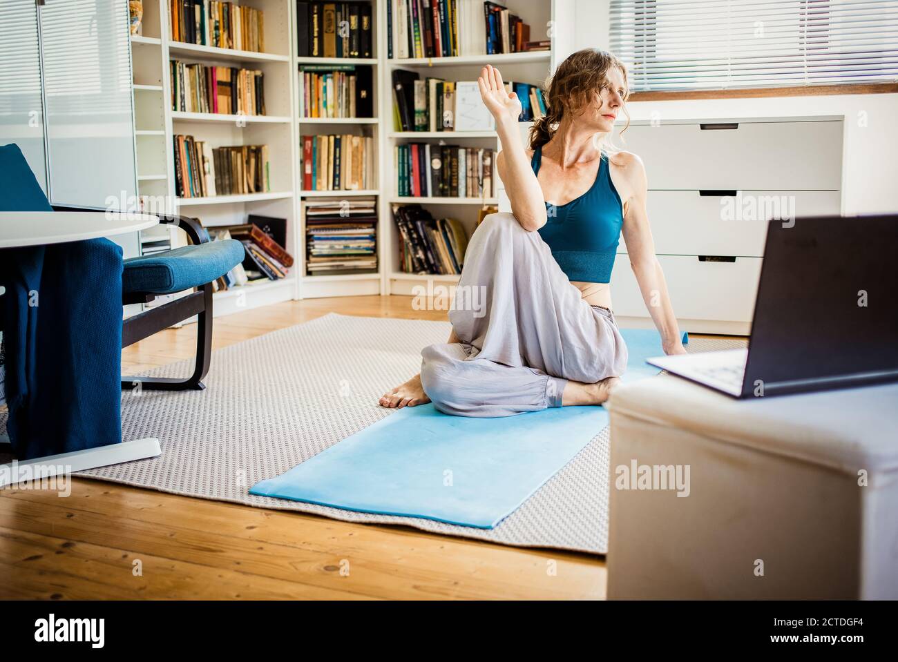 woman doing yoga asanas at home with laptop Stock Photo - Alamy