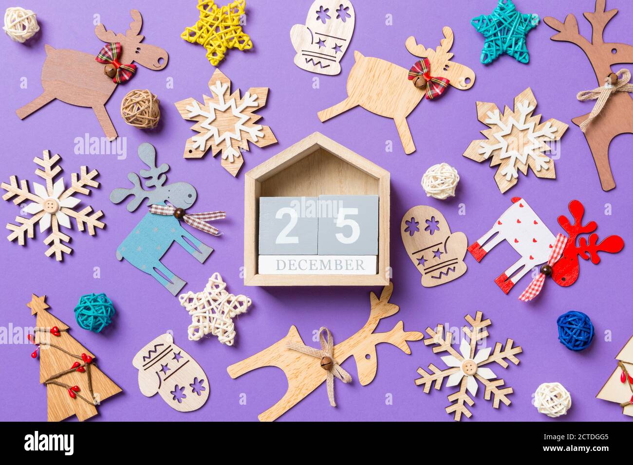Festive decorations and toys on purple background. Top view of wooden ...