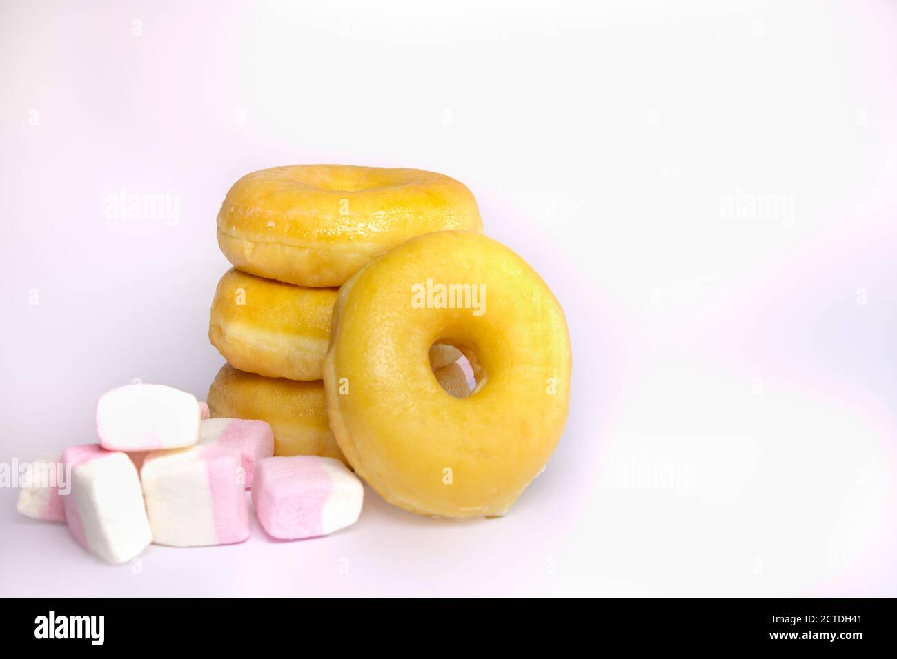 Four Donuts or Classic Donuts Stack with Marshmallows on a White ...