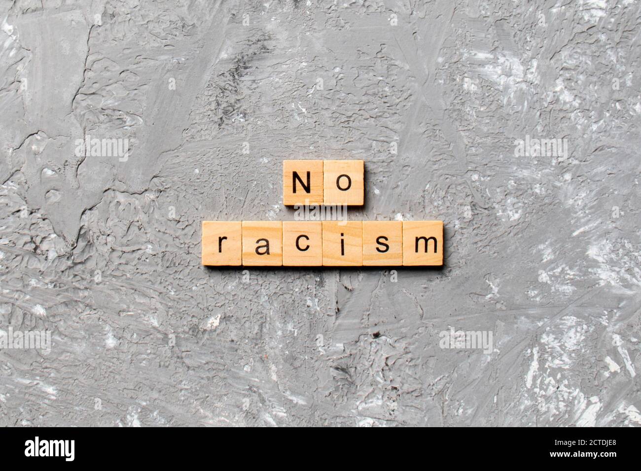 No racism word written on wood block. No racism text on table, concept ...