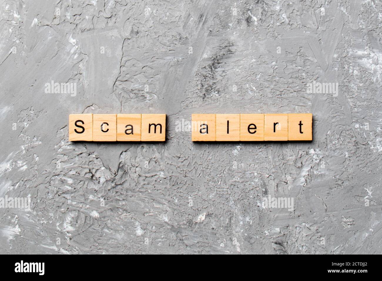 Scam alert word written on wood block. Scam alert text on table ... Scam alert word written on wood block. Scam alert text on table ...