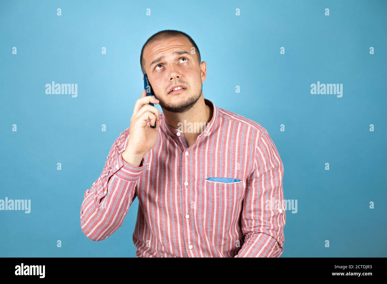 Russian business man over blue background having a conversation using ...