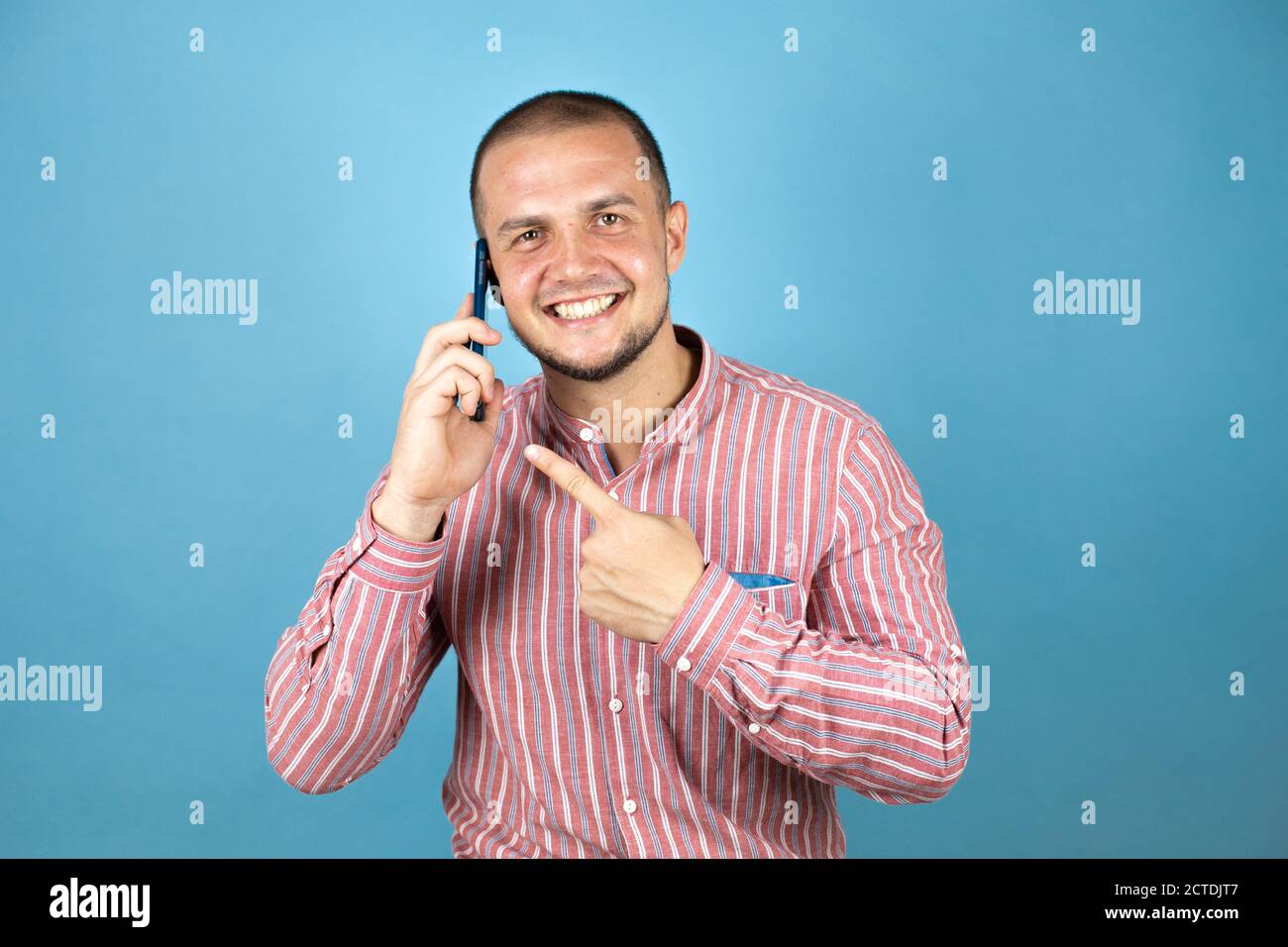 Russian business man over blue background having a conversation using ...