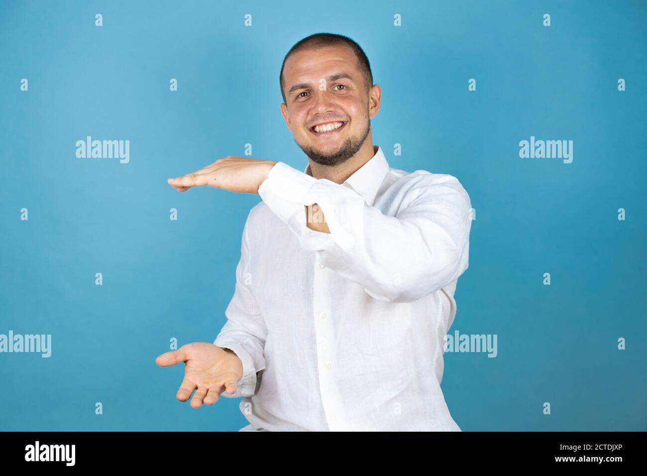 Russian business man wearing white shirt standing over blue background ...
