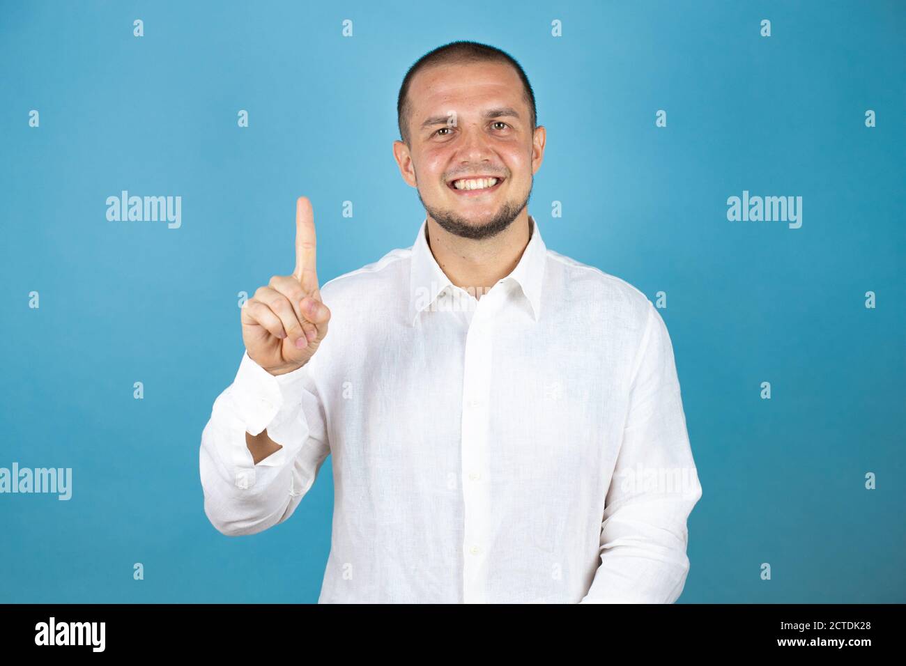 Russian business man wearing white shirt standing over blue background ...
