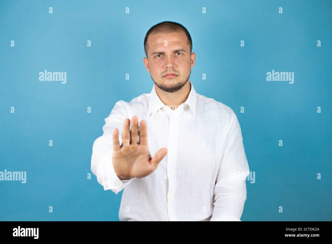 Russian business man wearing white shirt standing over blue background ...