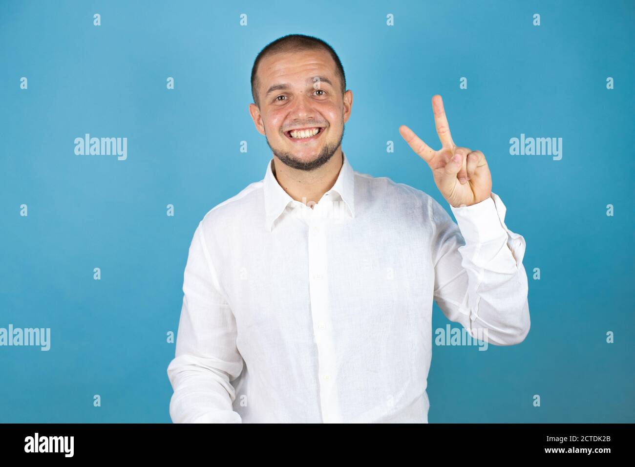 Russian business man wearing white shirt standing over blue background ...
