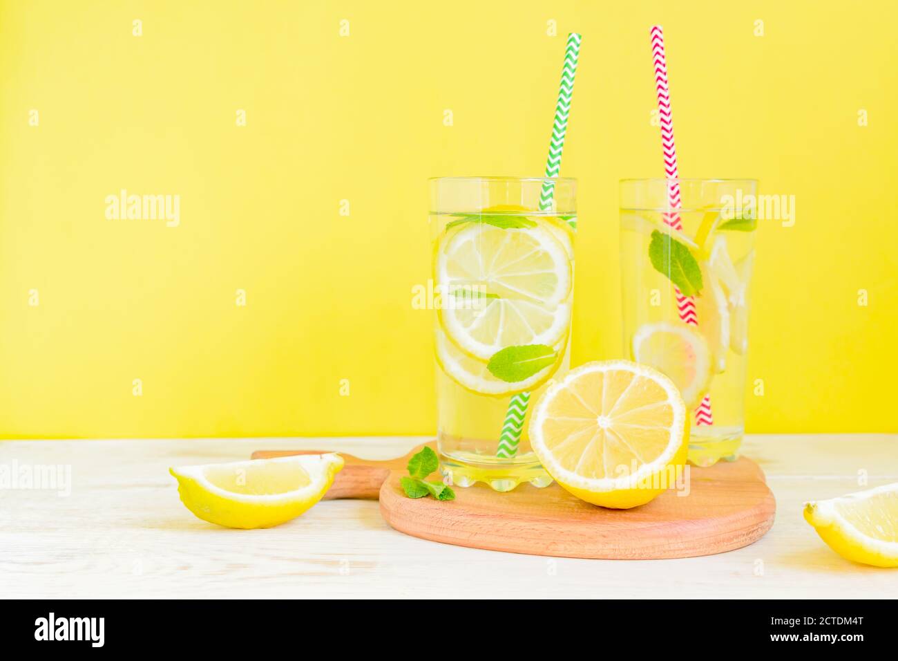 Homemade lemonade with lemon and mint on colored yellow background ...