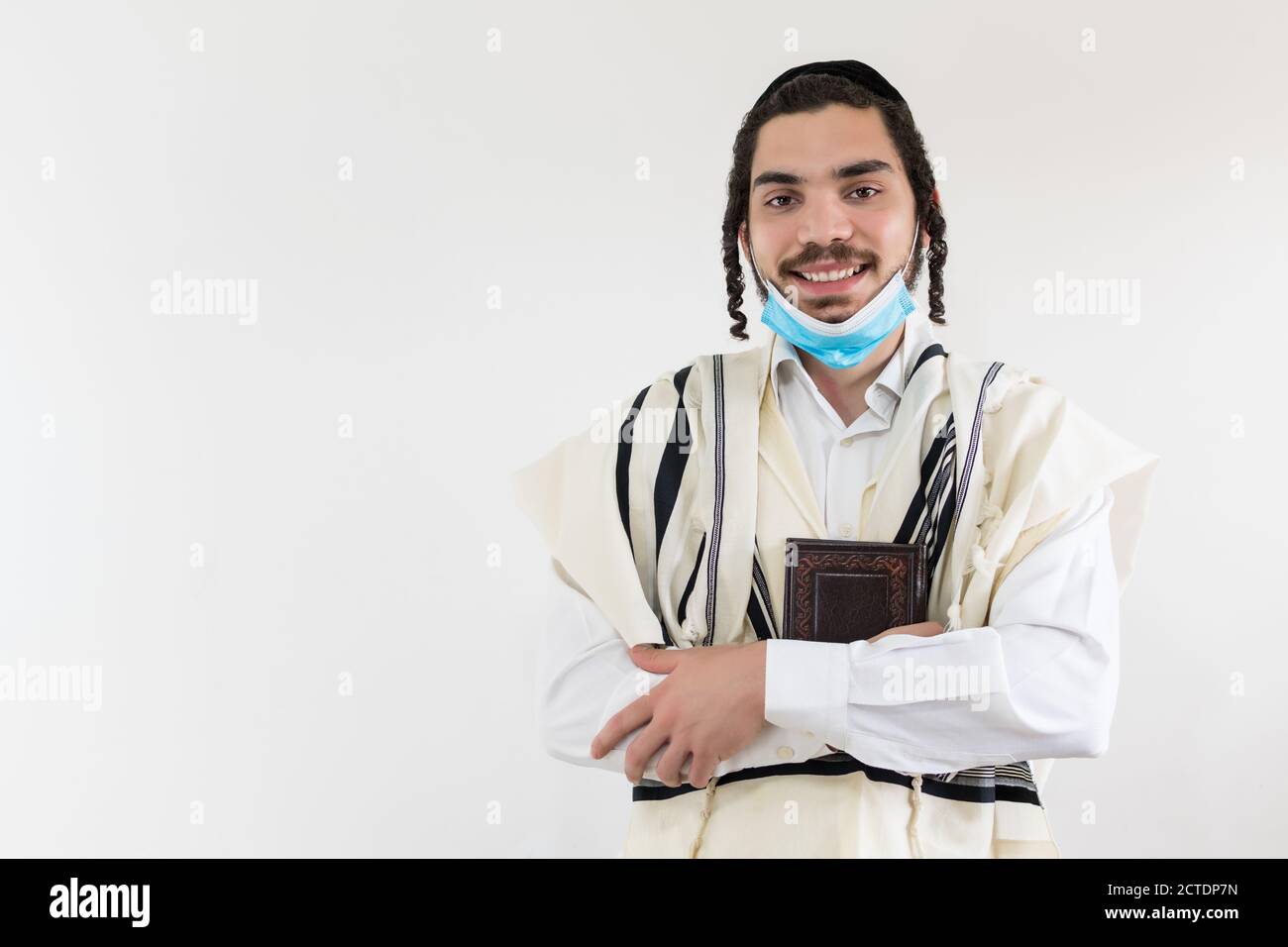Young Orthodox Jew smiling and wearing a protective mask Stock Photo ...