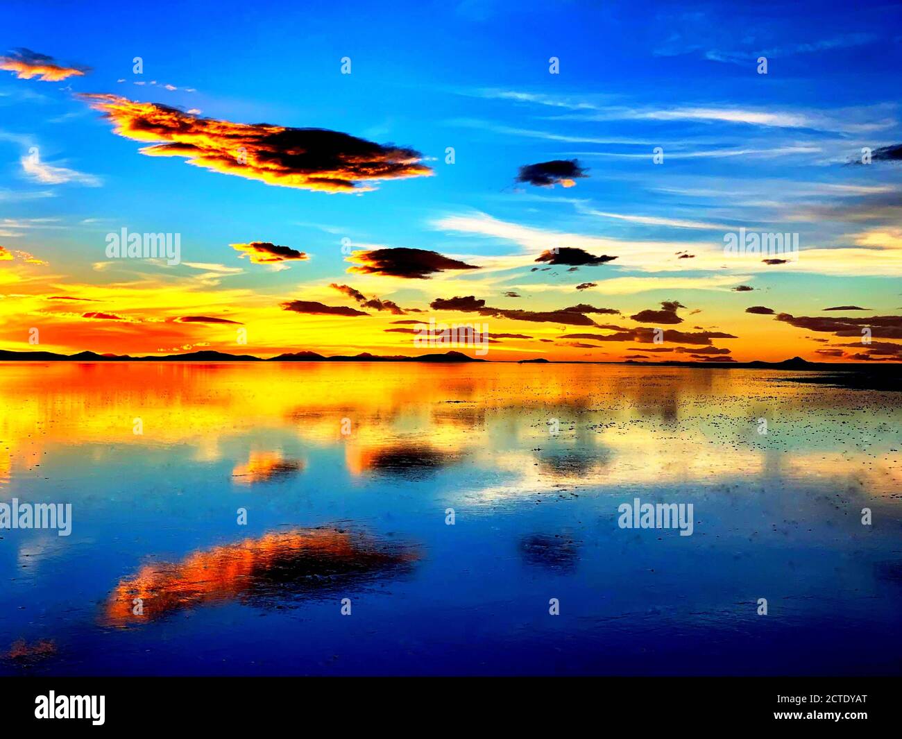 Impressive sunset. Stunning clouds reflection in the salt lake water ...