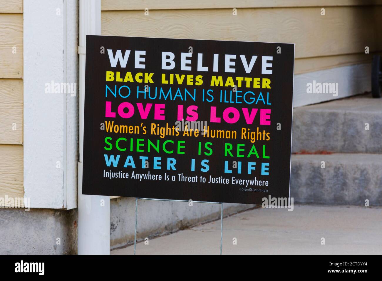 Sign posted in front yard of suburban home voicing resident's beliefs ...