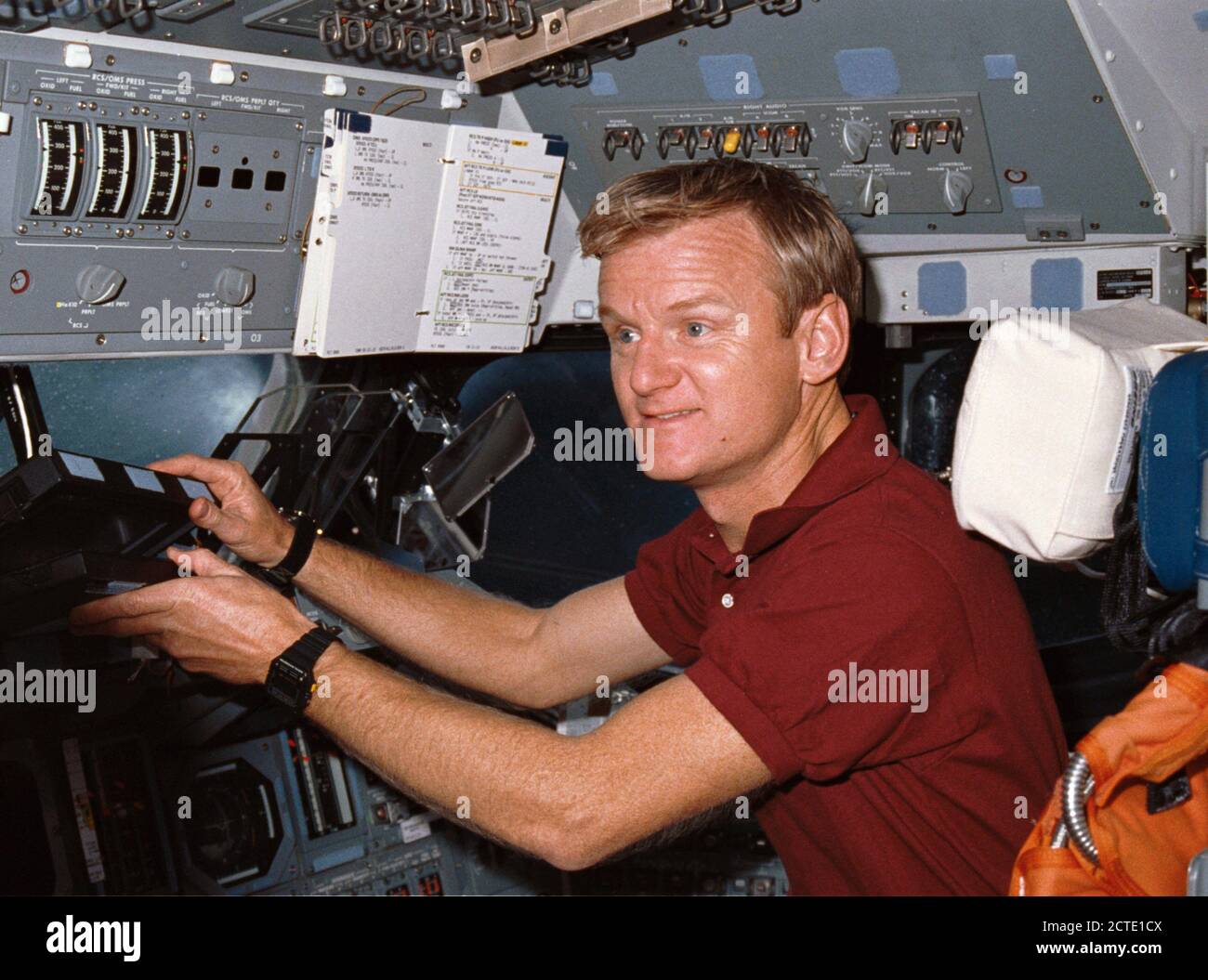 STS-36 Pilot John H. Casper reaches for the shuttle portable onboard ...