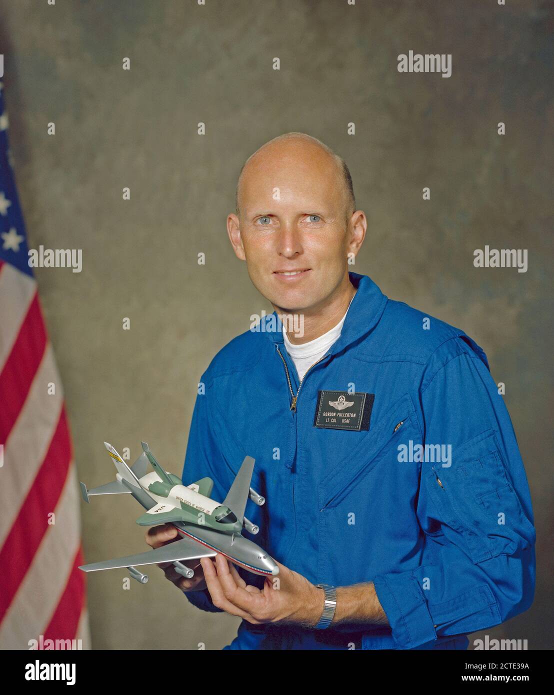 (8 Sept 1976) --- Astronaut C. Gordon Fullerton in flight suit holding ...