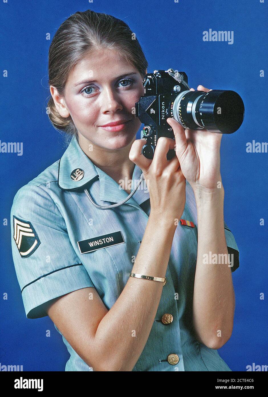 1979 - A female U.S. Army photographer demonstrates the use of a 35mm ...