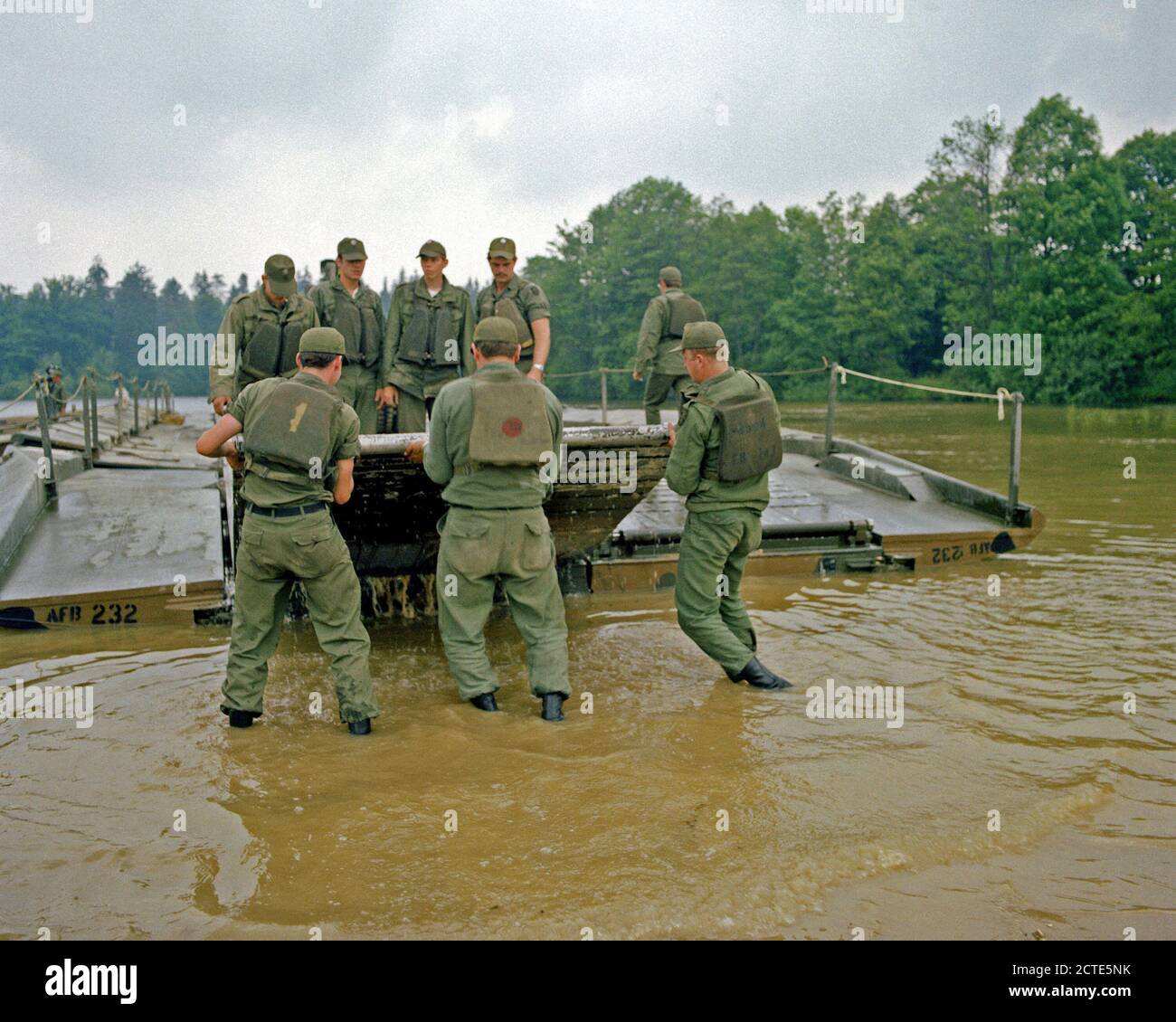 A ribbon bridge is assembled by members of the 1457th Engineering ...