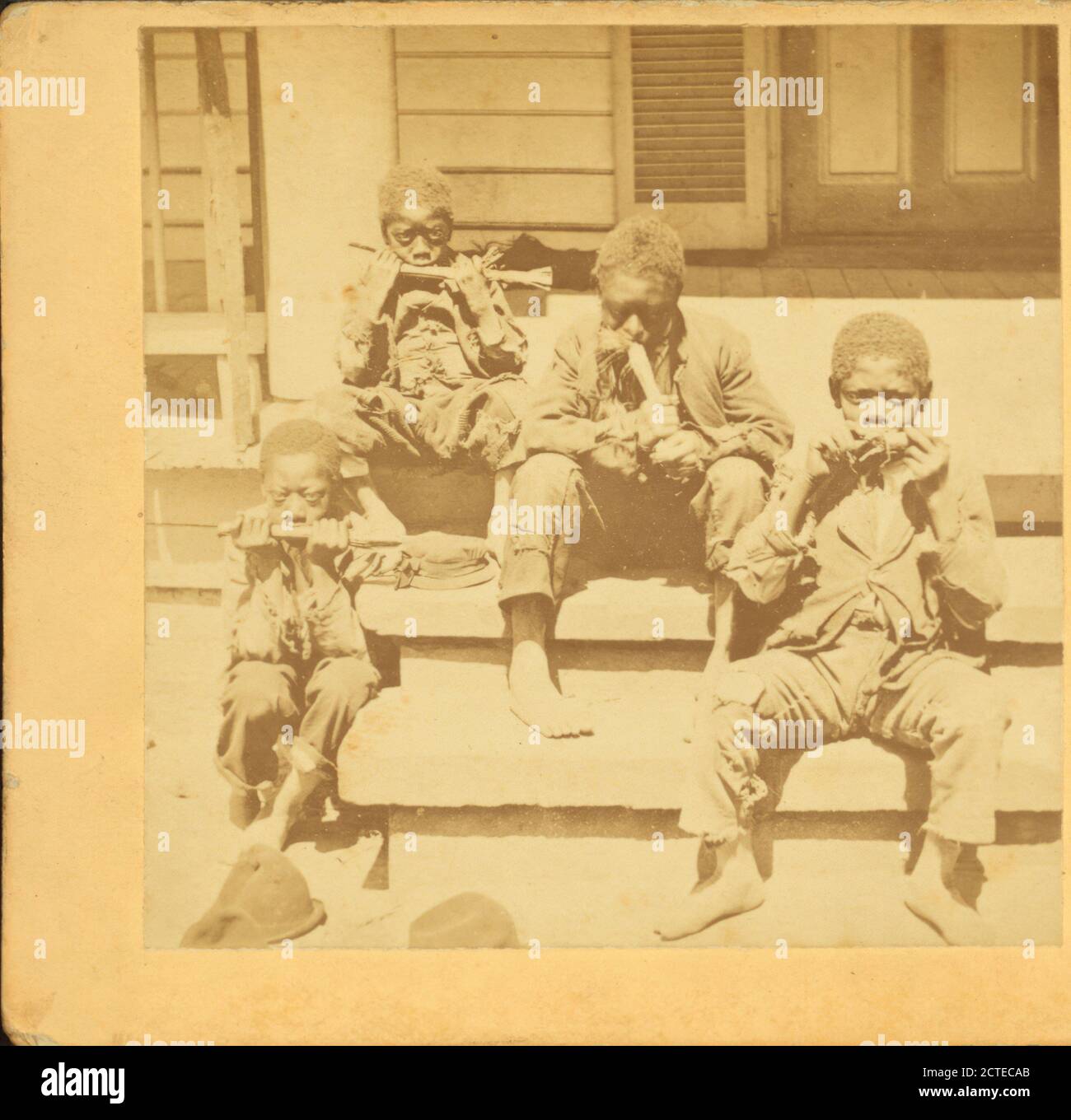 Distinguished southerners, grinding cane. Children chewing sugar cane ...