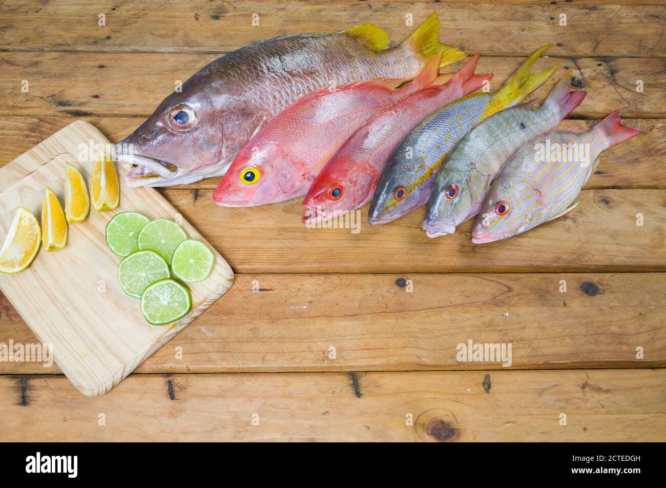 Caribbean Fresh fish seafood on old wooden table. Top view. Close-up ...