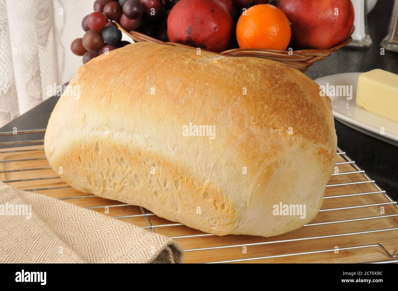 A loaf of hot bread on a cooling rack Stock Photo - Alamy