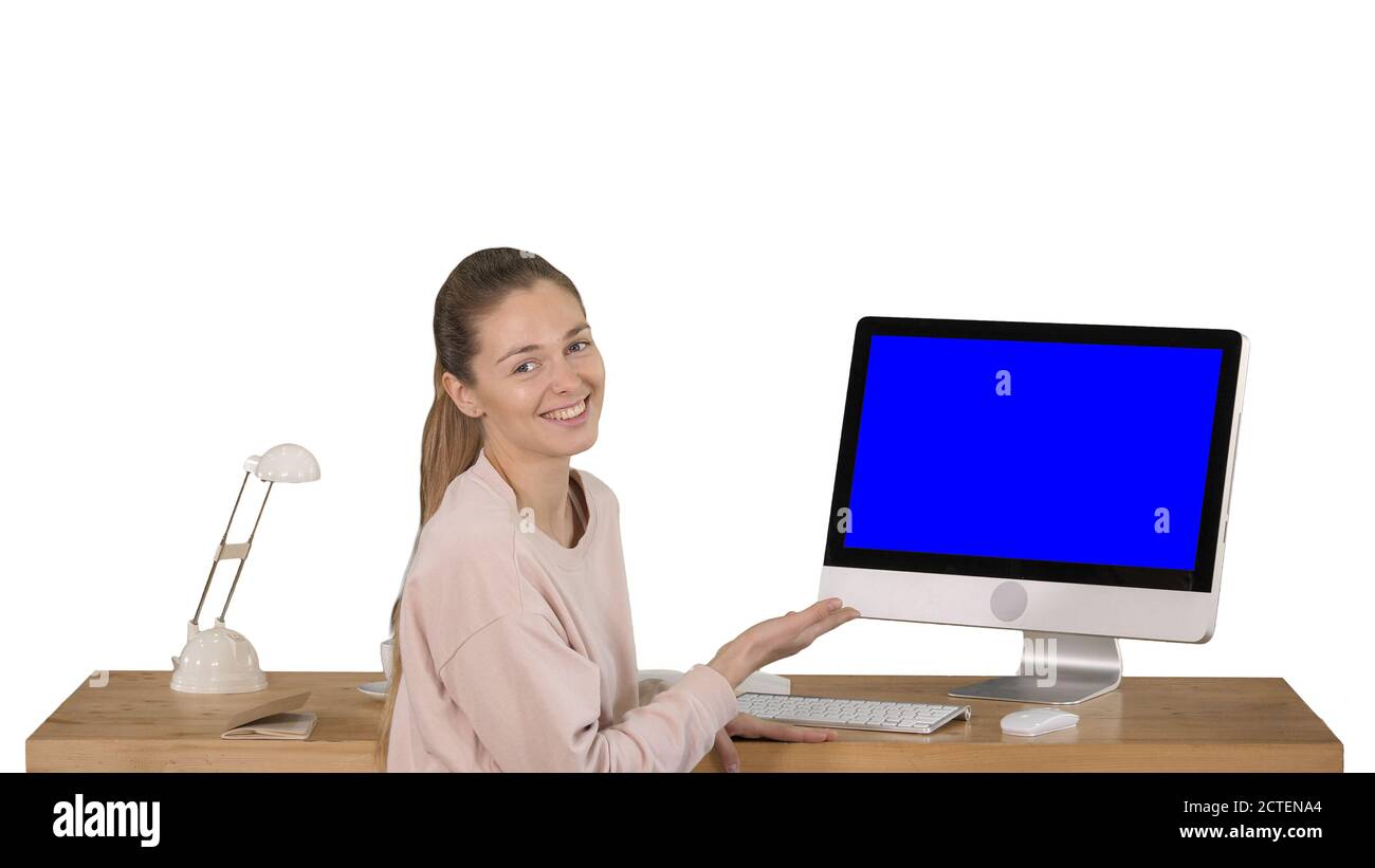 Charming woman presenting something on the screen of computer talking ...