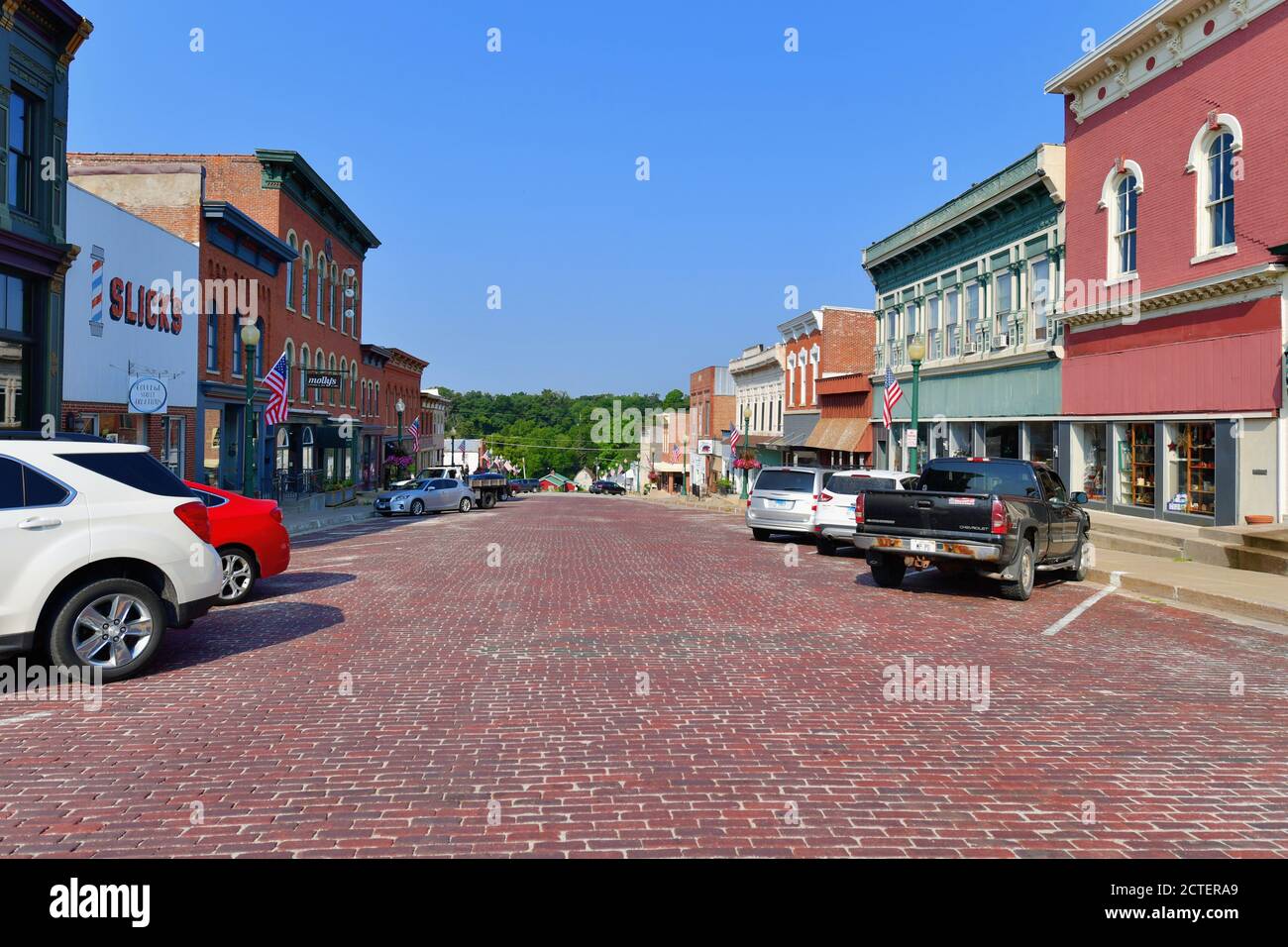 Mt. Carroll, Illinois, USA. Some colorful building facades line a brick ...