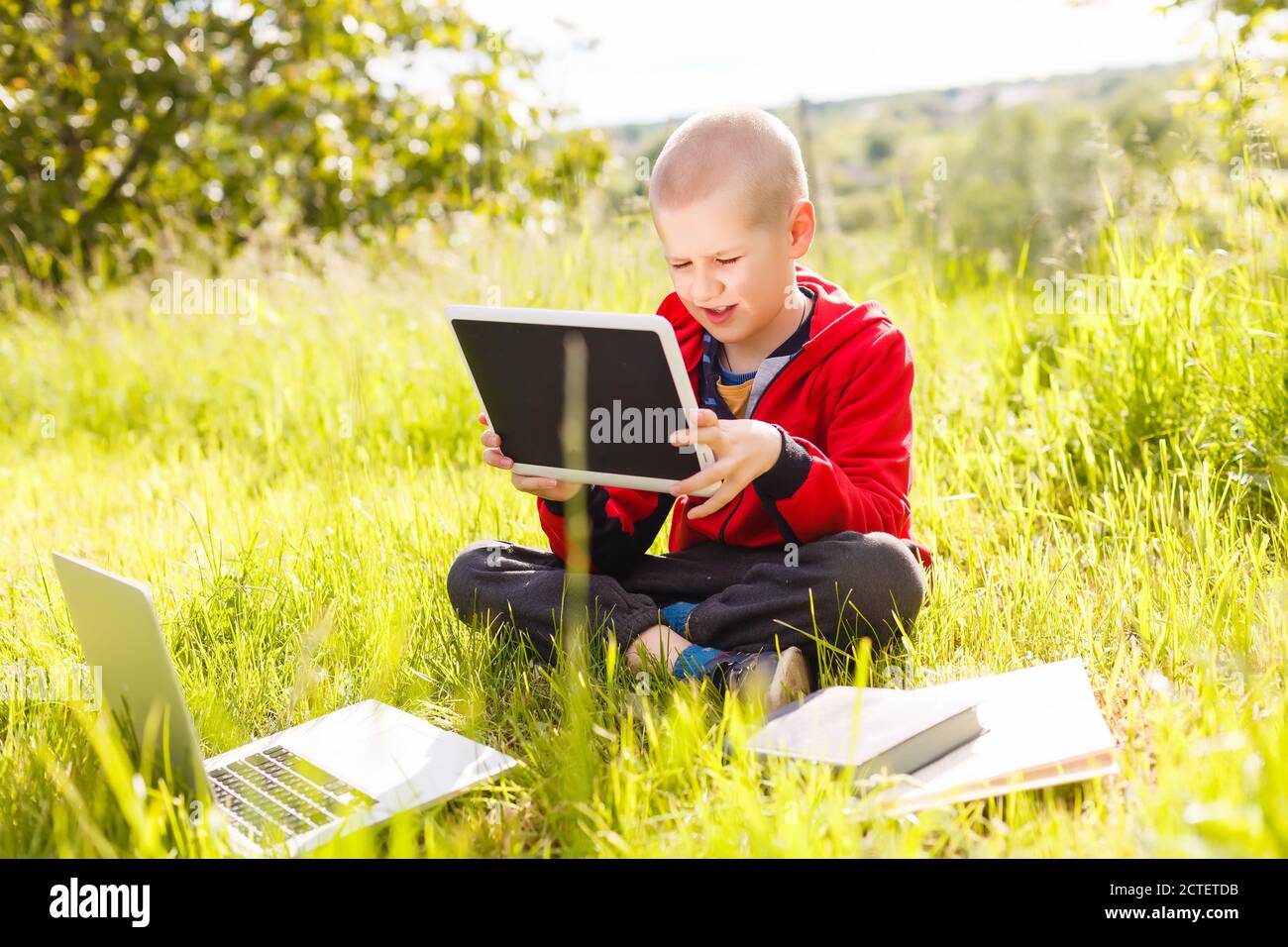 Children, education, learning, technology concept. Little boy with ...