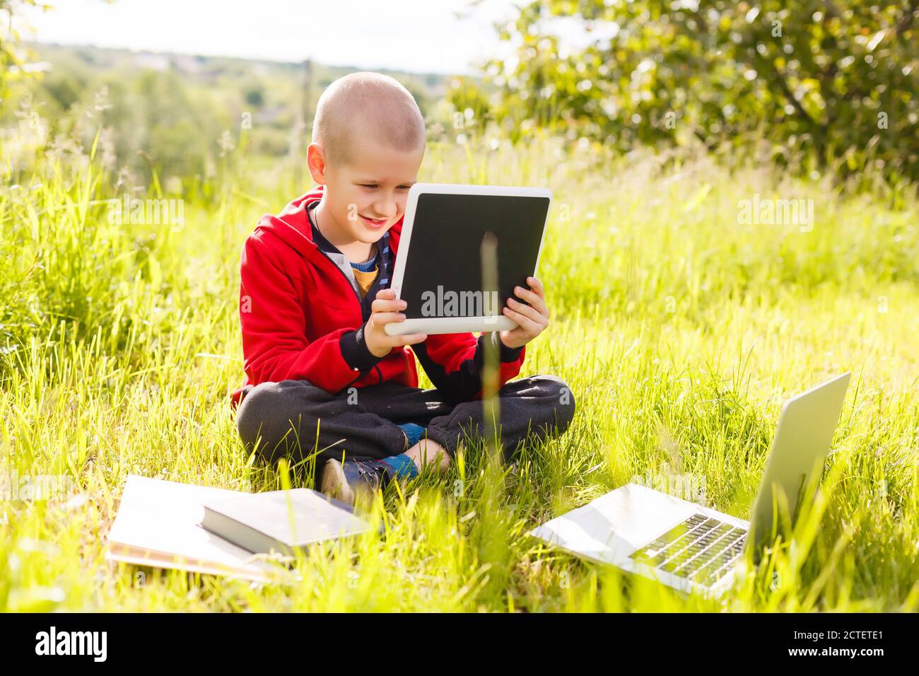 Children, education, learning, technology concept. Little boy with ...