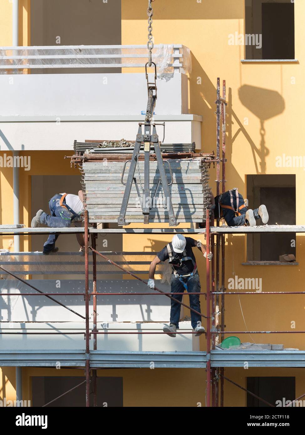 Workers at Work on a Scaffold in a Building Site for the Construction ...