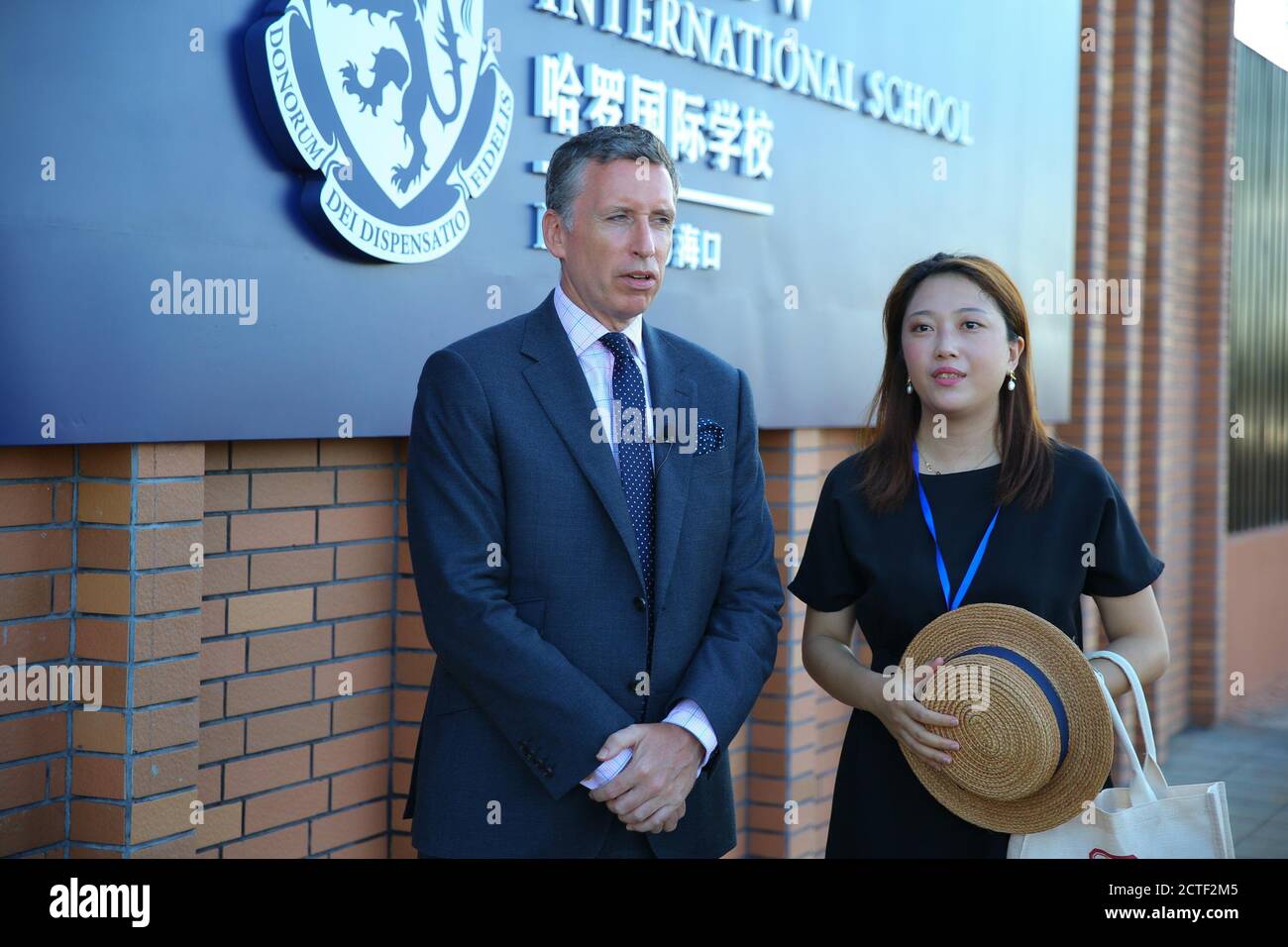 Charles Ellison, the head master of Harrow Shanghai, left, arrives at ...