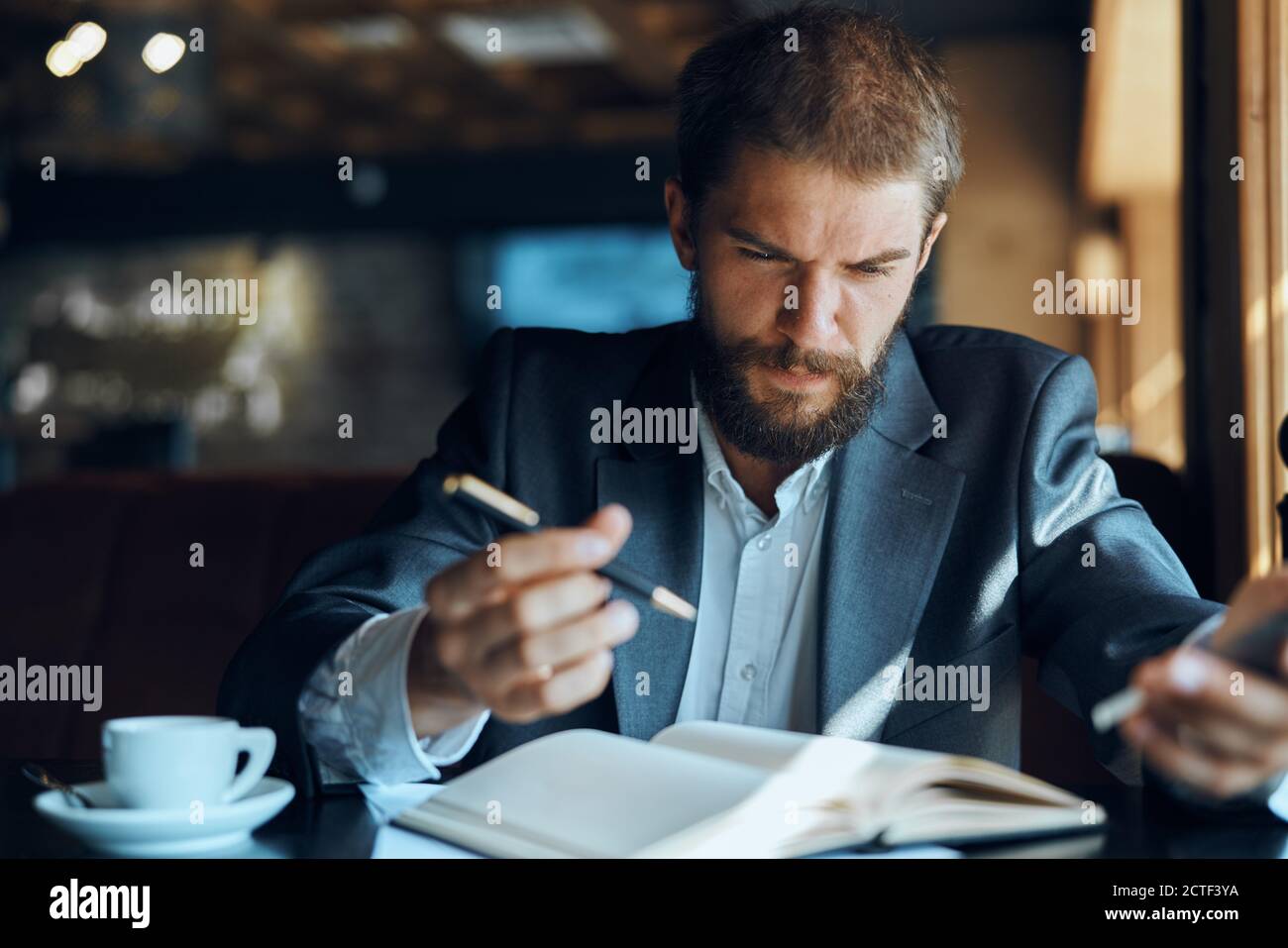 business man sitting at a table in a cafe documents work official ...