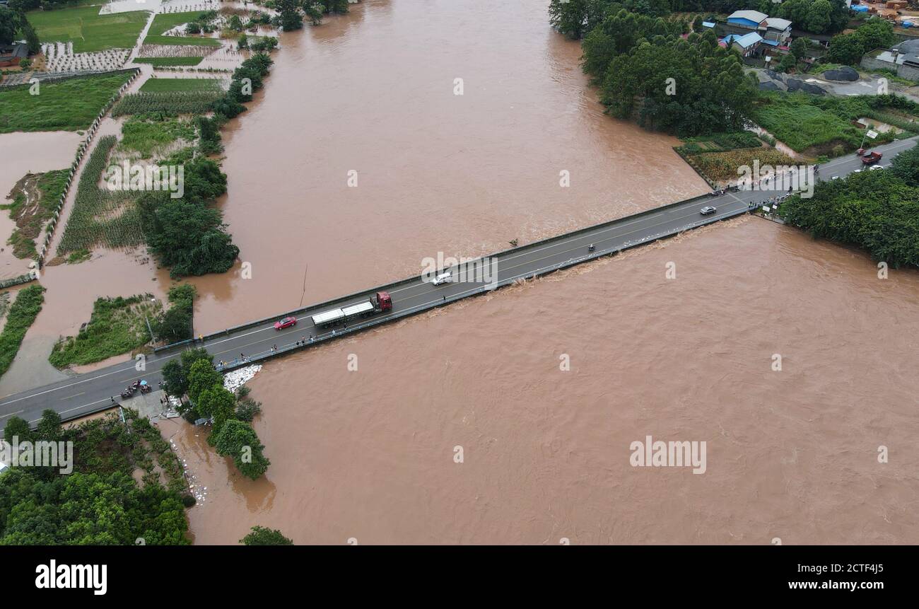 A bridge is surrounded by water due to rising water level caused by ...