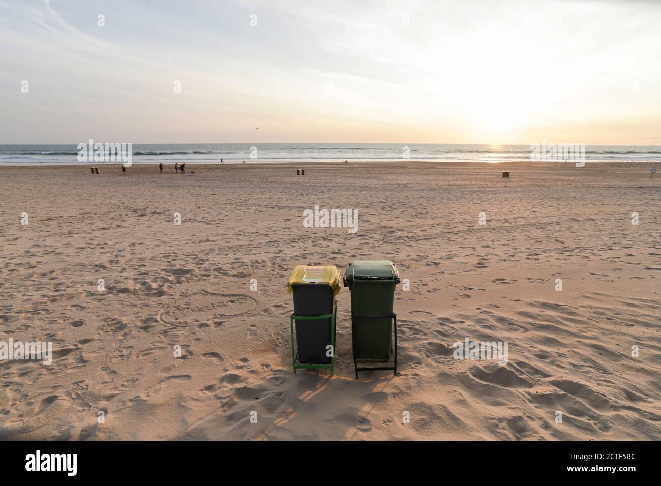 Isolated trash bins on the beach facing the Atlantic Ocean in Costa da ...