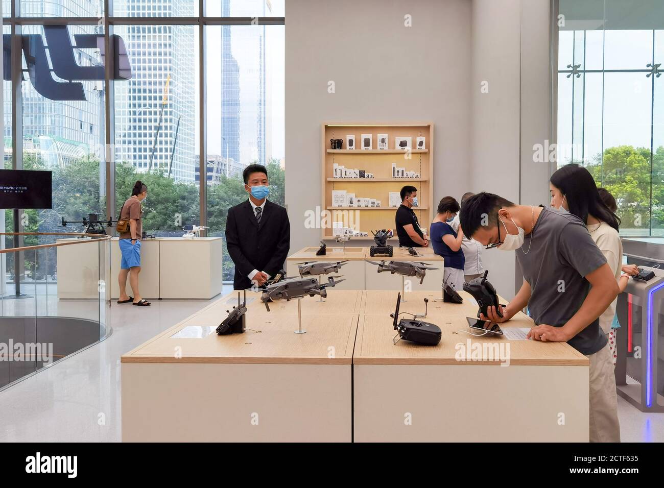 Customers experience products at the newly opened DJI flagship retail ...