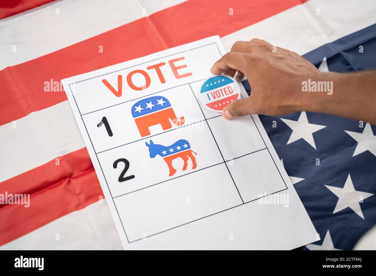 Hands placing I voted Sticker on republican party symbol - concept of ...