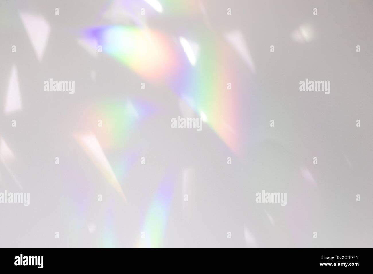 Blurred rainbow light refraction texture on white wall Stock Photo - Alamy