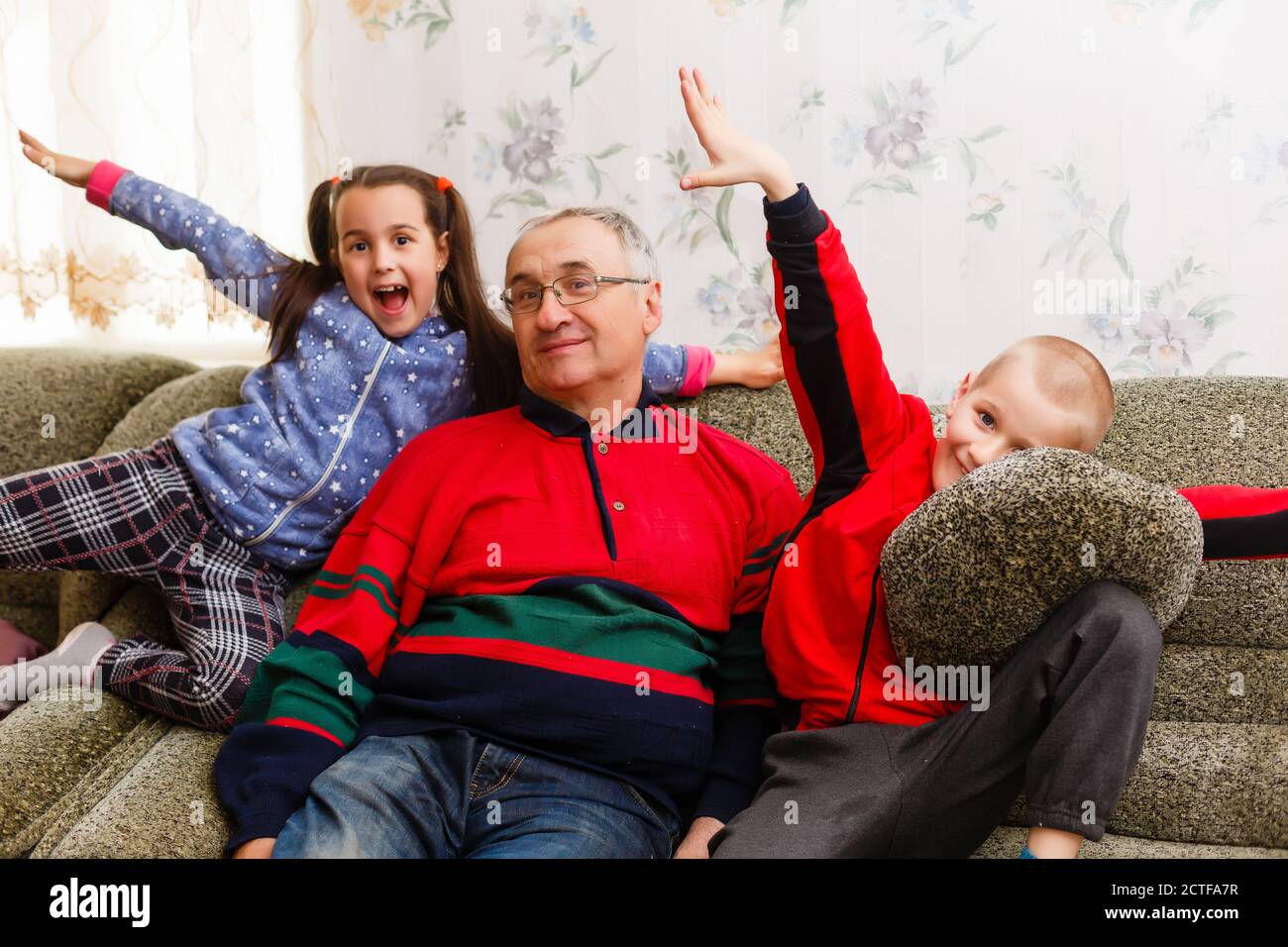 Grandparents spending time with grandchildren on couch Stock Photo - Alamy