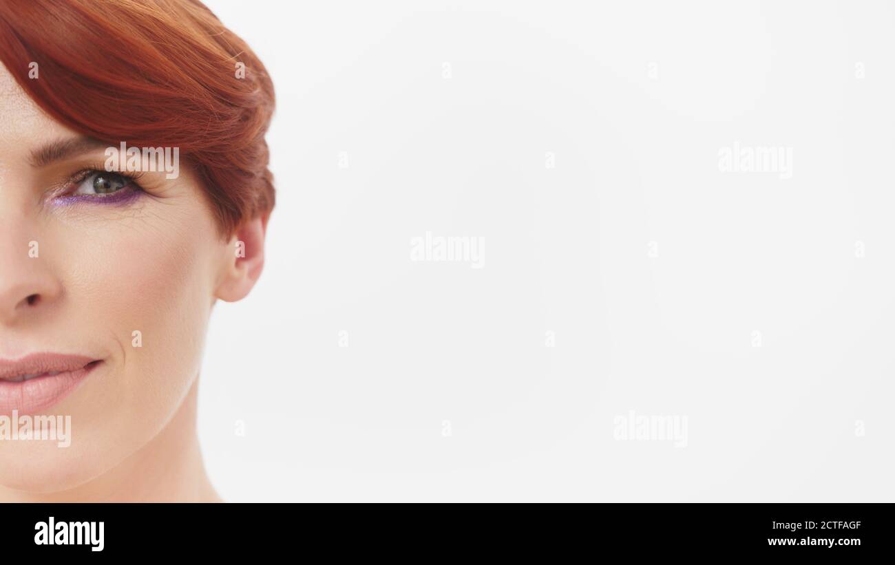 Beauty half face shot. Beautiful middle aged caucasian redhead woman ...