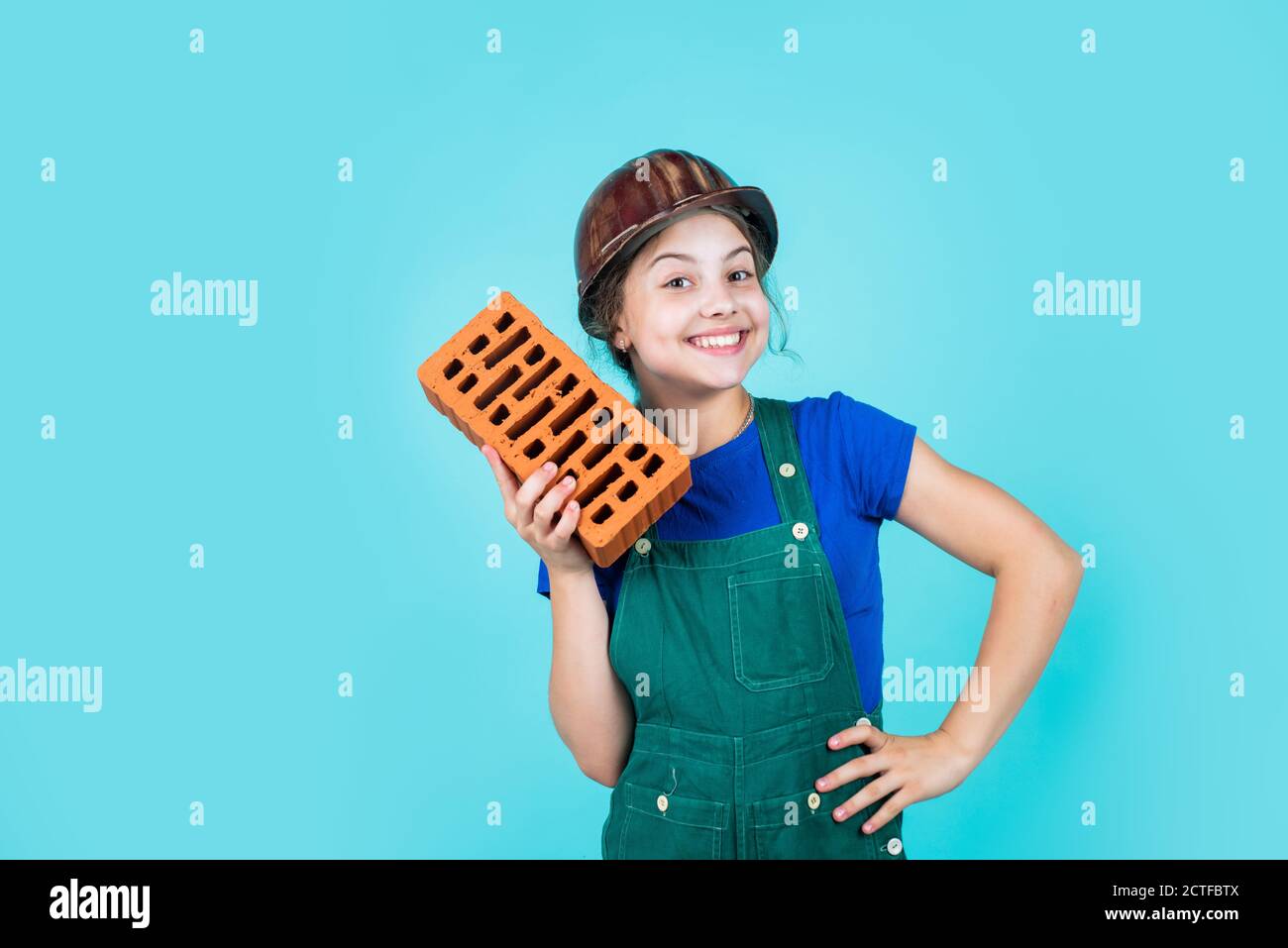 labour day. Little girl bricklayer. learning how to build. Little ...