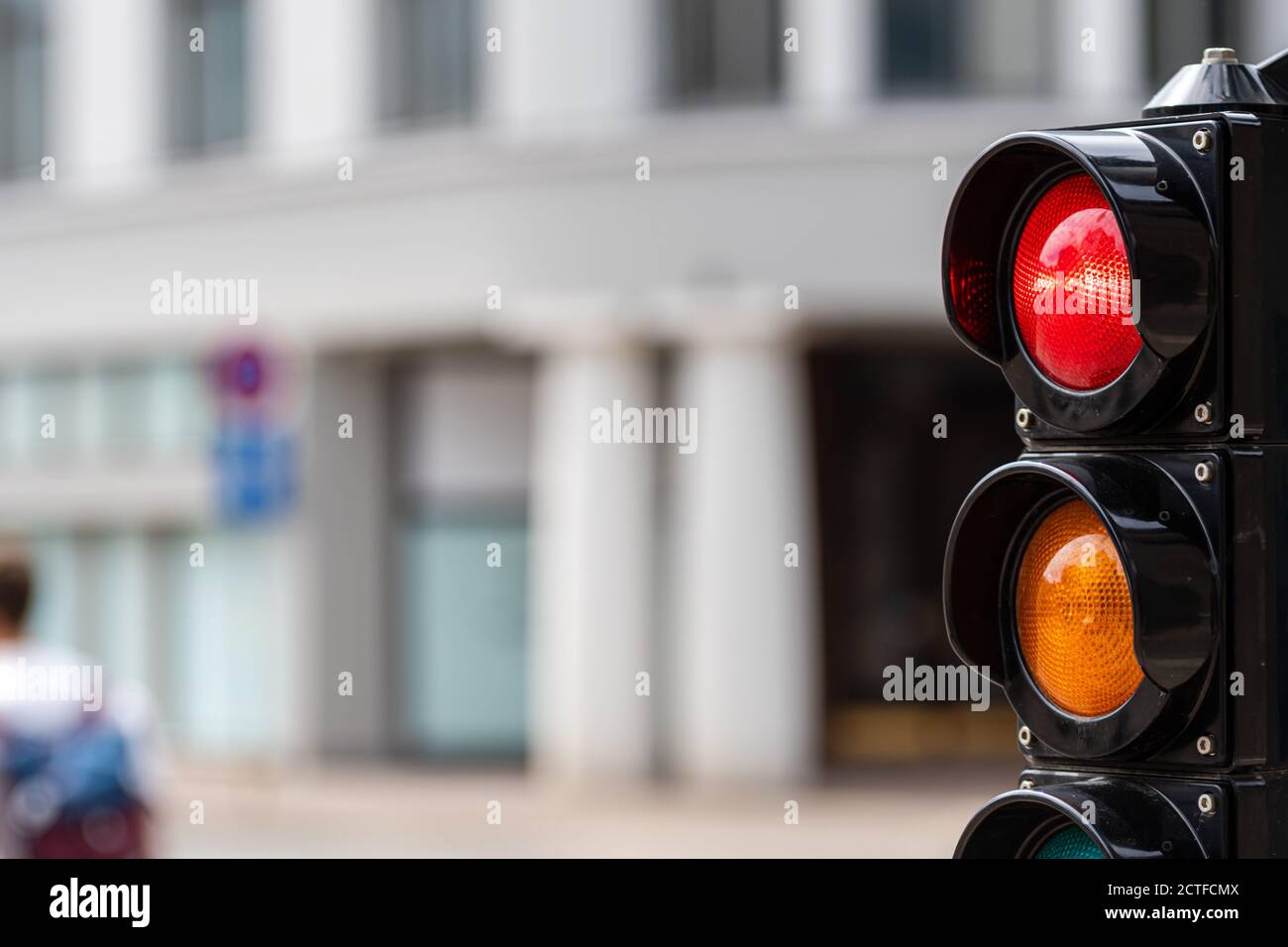 traffic control semaphore with stop light on a defocused city ...