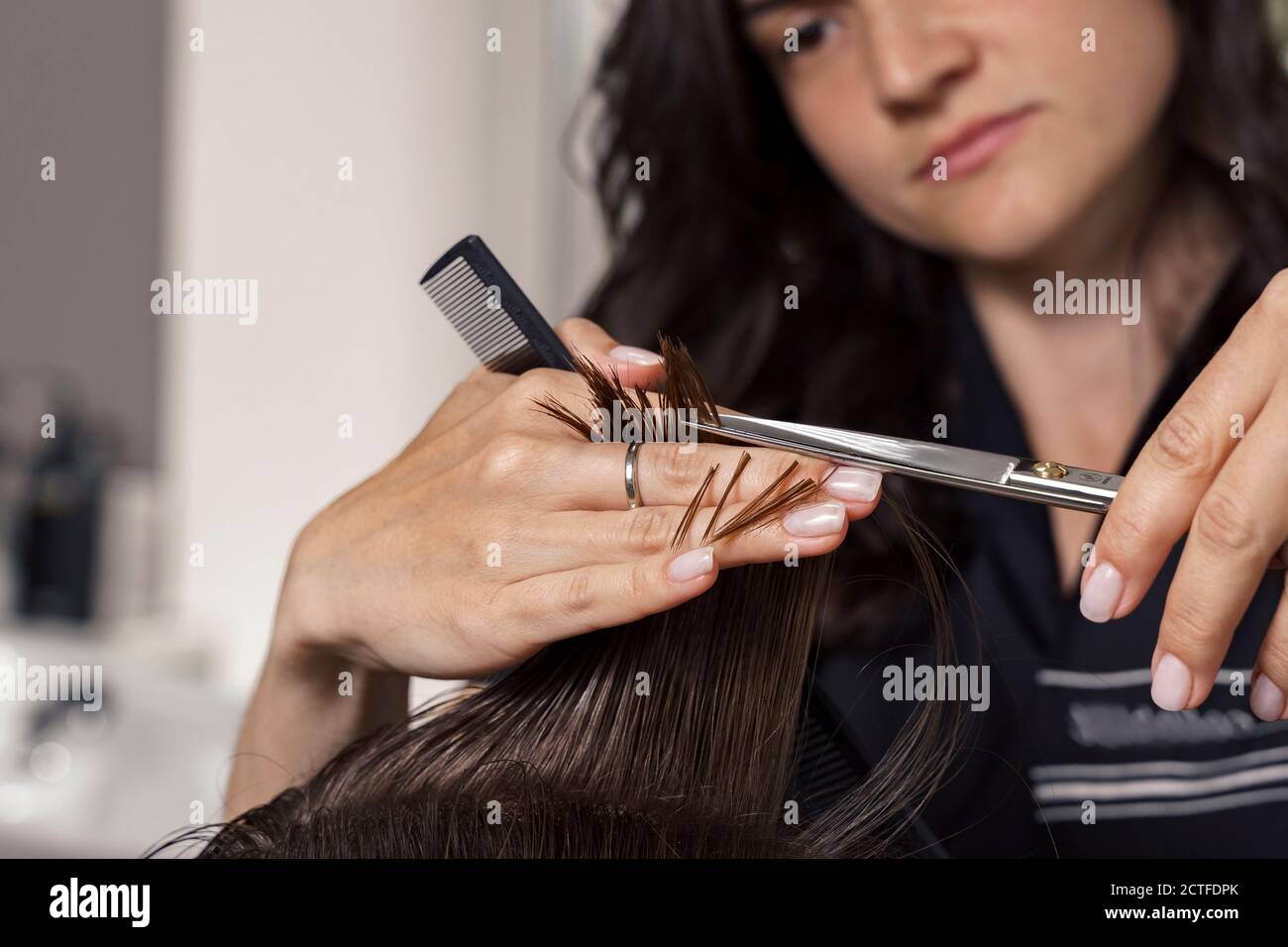 woman getting a haircut in a beauty salon. haircut process. selective ...