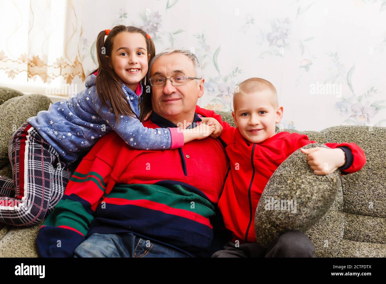 Grandparents spending time with grandchildren on couch Stock Photo - Alamy