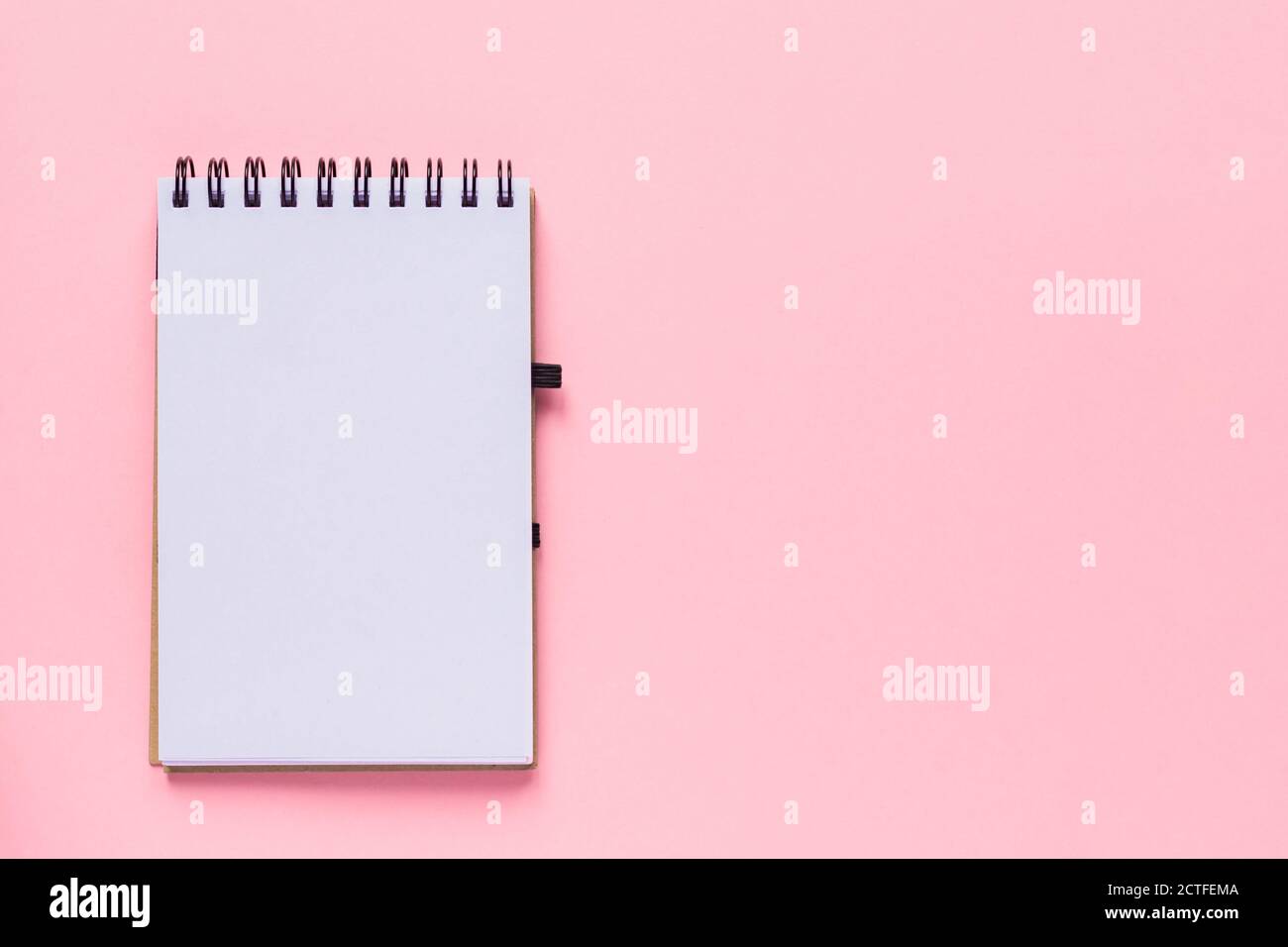 Clean spiral note book for notes and messages on pastel pink background ...