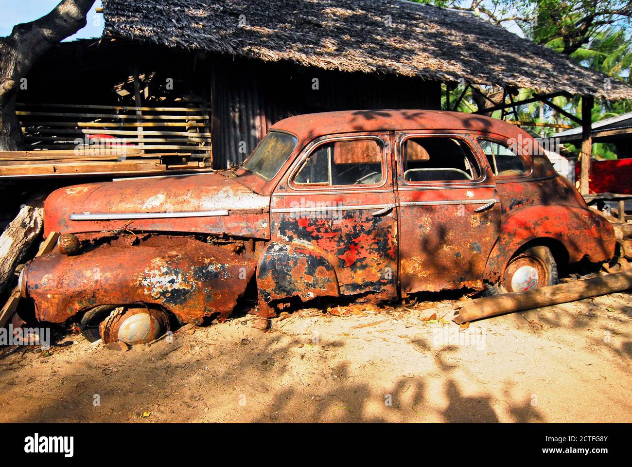 Wrack of a red colored, rusty Chevrolet car of the 50'th, stranded at a ...