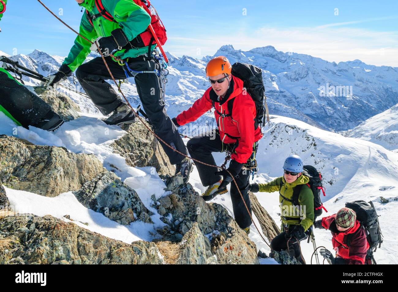 Mountain guide leading a group of alpinists up to Monte Rosa Glaciers ...