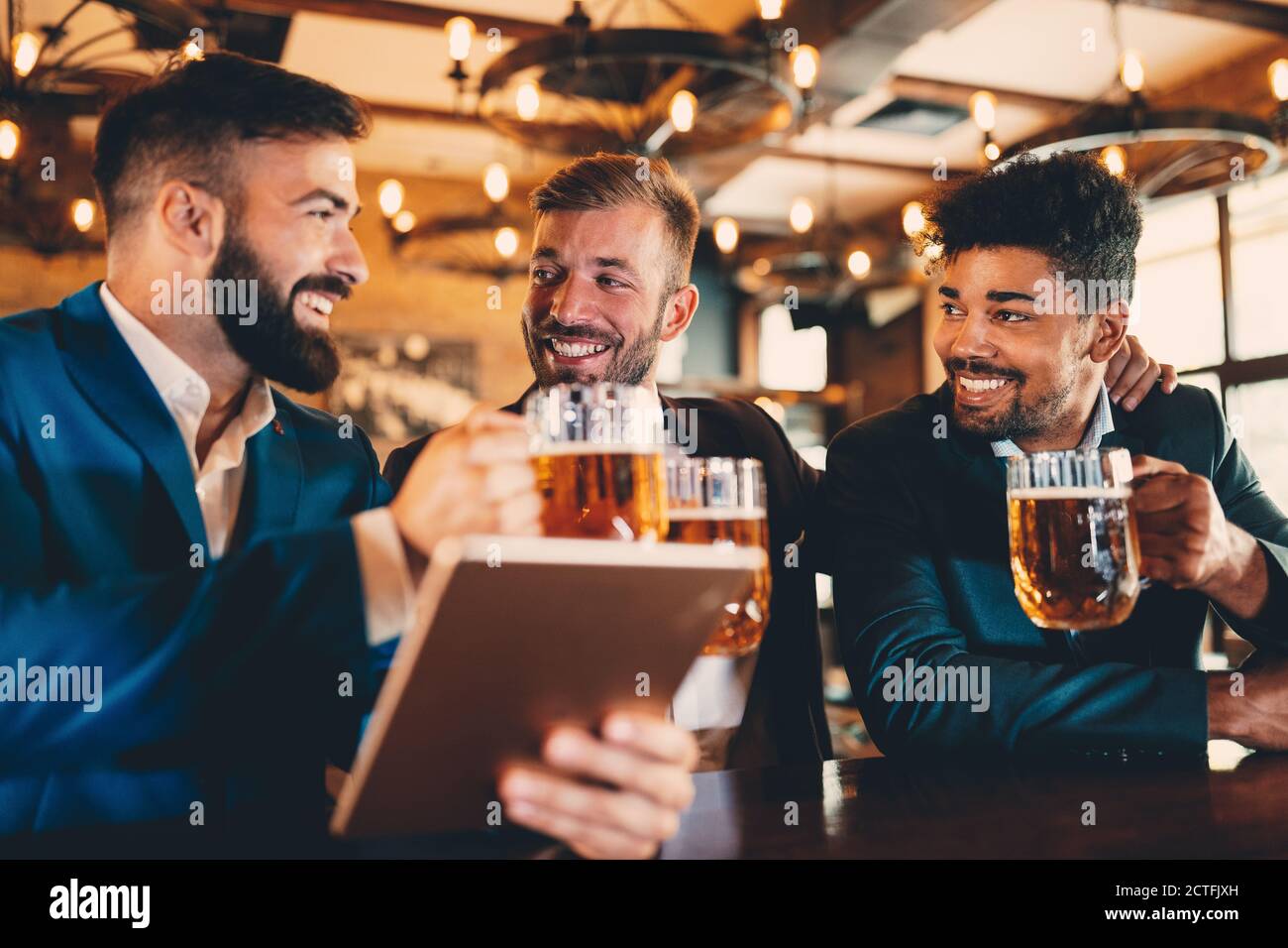 Businessmen sitting bar beer hi-res stock photography and images - Alamy